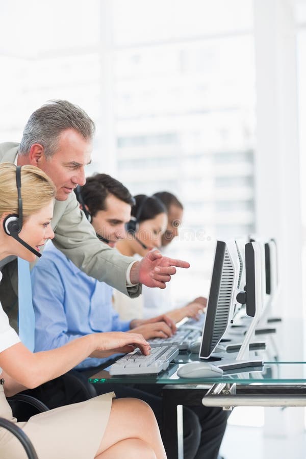 Manager and Executives with Headsets Using Computers Stock Image ...