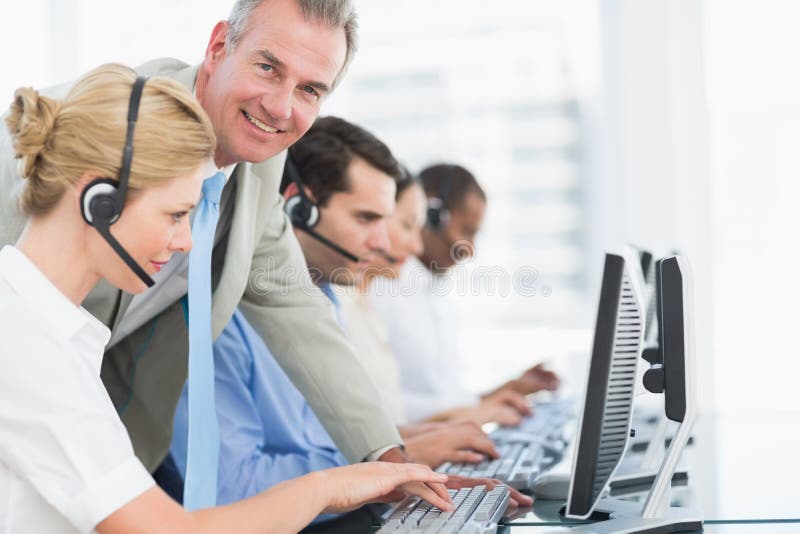 Manager and Executives with Headsets Using Computers Stock Image ...