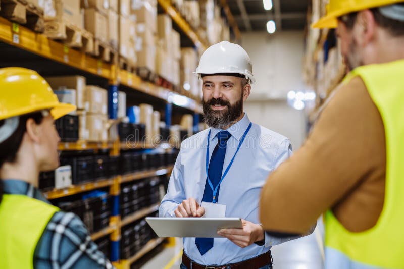 Manager Explaining Work To His Employers in Warehouse. Stock Photo ...