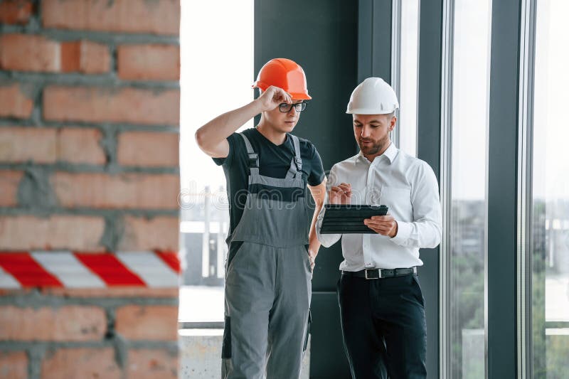 Manager with Foreman are Working on the Construction Site Together ...