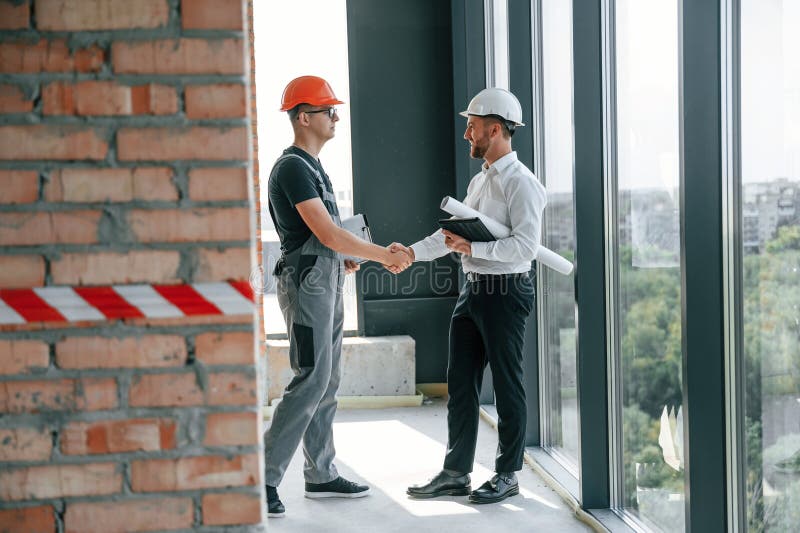 Manager with Foreman are Working on the Construction Site Together ...