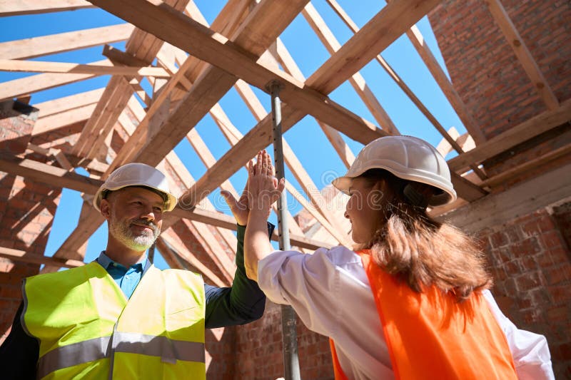 Manager and General Constructor Giving High-five, Finishing Wall ...