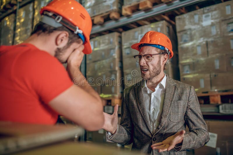 Manager Having a Tough Conversation with the Warehouse Worker and ...