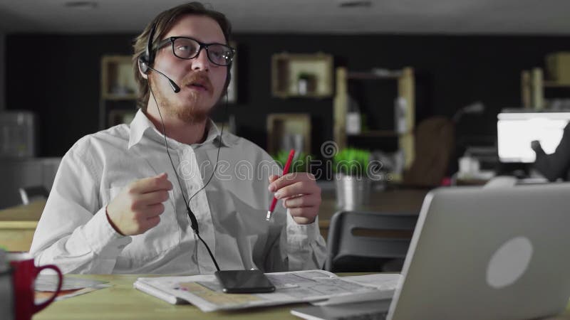 Manager in Headphones is Working at Desk in Office Stock Video - Video ...