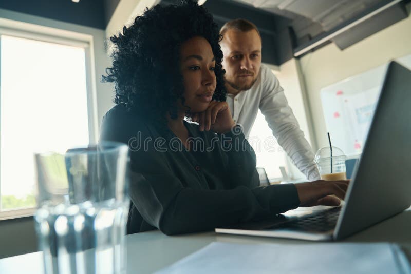 Manager Helping Female Colleague with Project Work Stock Photo - Image ...