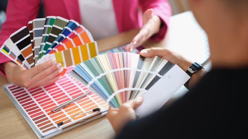 Manager Helps Client Choose Color from Variety of Samples in Office ...