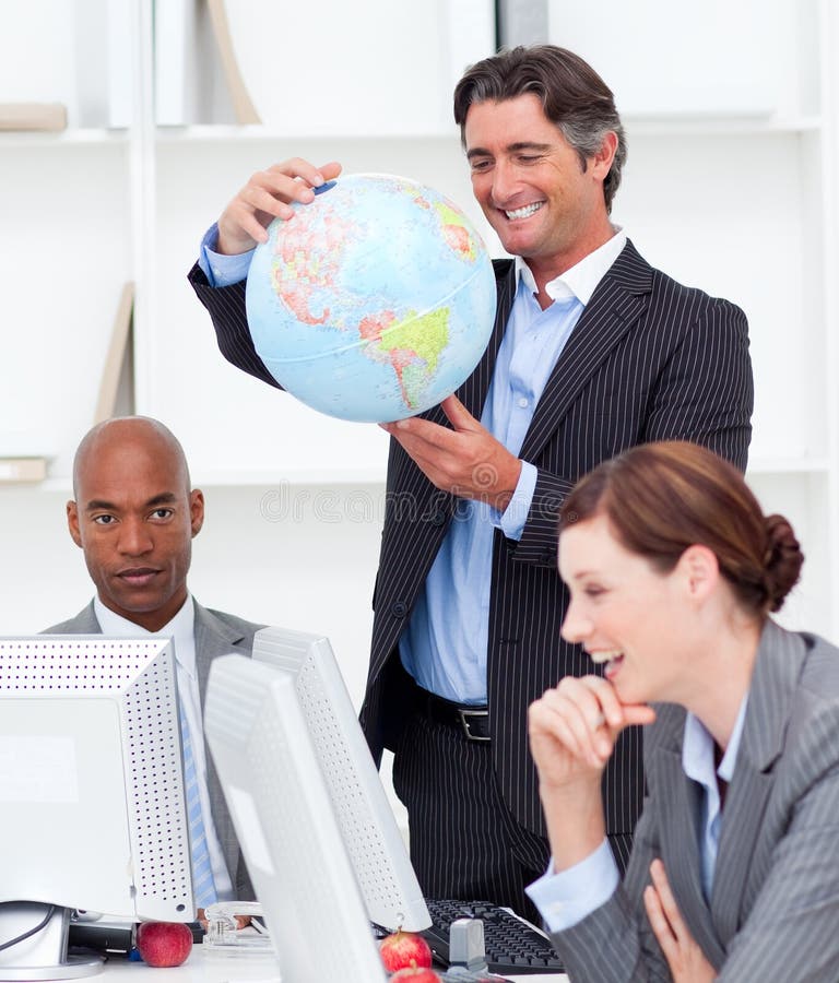 Manager Holding a Globe while His Team is Working Stock Photo - Image ...