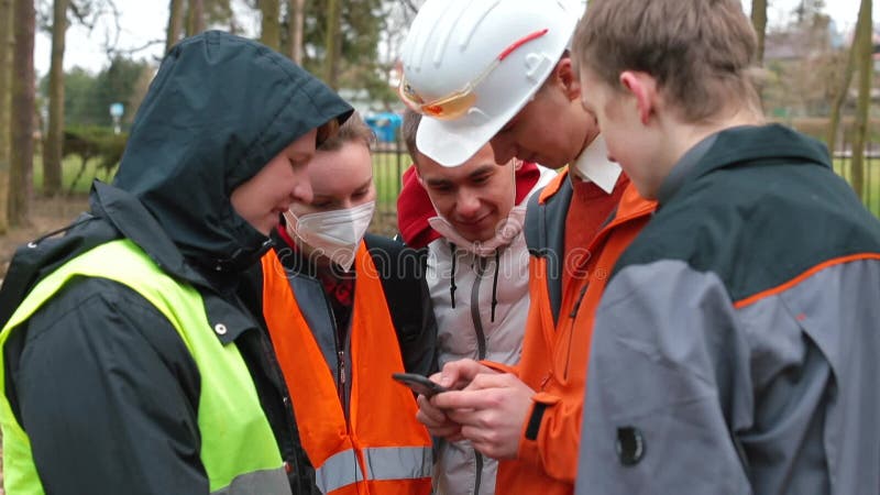 The Manager Indicates Work Plan on Phone. Workers Special Clothes ...