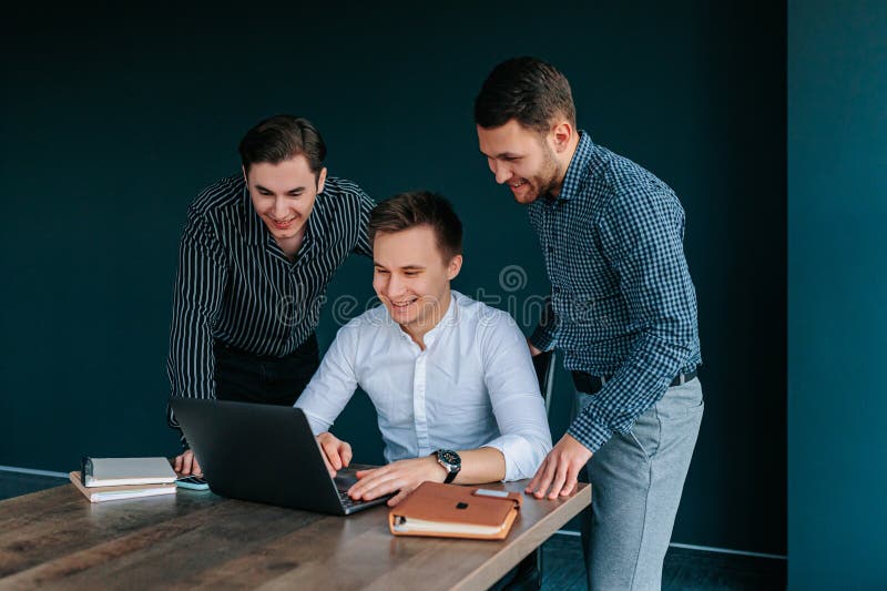 A Manager Leading a Team of Three Young Office Workers As they Work on ...