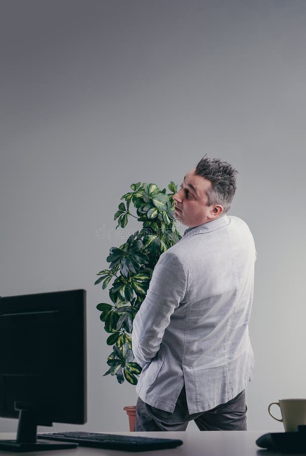 Manager Looking Over Shoulder while Standing at Office Desk Stock Photo ...