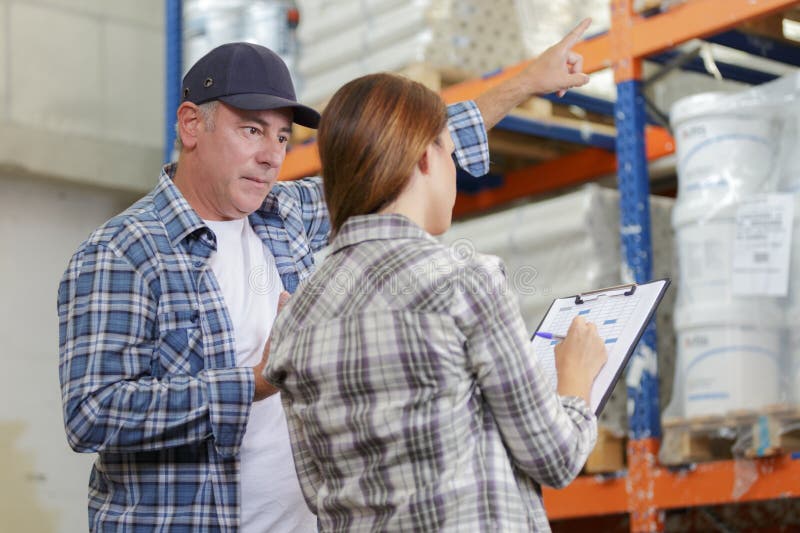 Manager Noting on Clipboard and Worker in Warehouse Stock Photo - Image ...