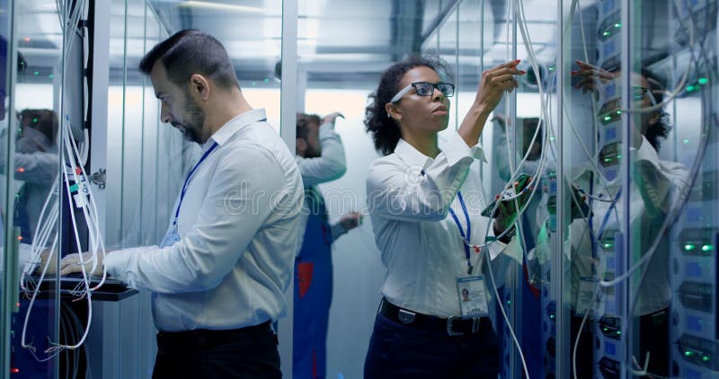 Two Men Performing Maintenance in a Data Center Stock Image - Image of ...