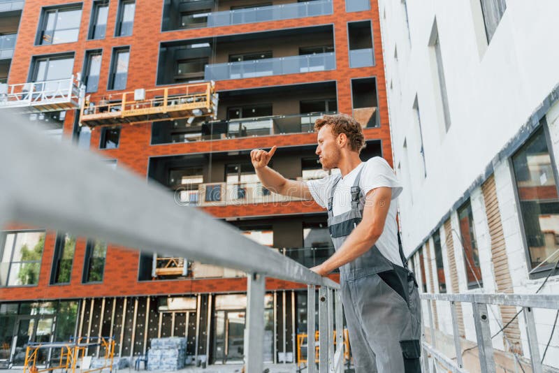Manager of Project. Young Man Working in Uniform at Construction at ...