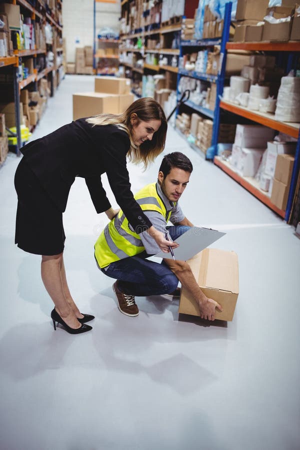 Manager Showing Clipboard To Worker Stock Photo - Image of vest ...