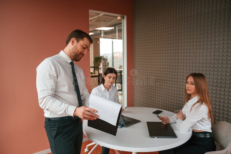 Manager is Showing the Plan Project. Three Business People are Working ...