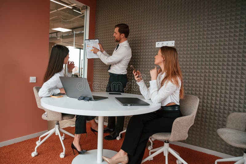 Manager is Showing the Plan Project. Three Business People are Working ...