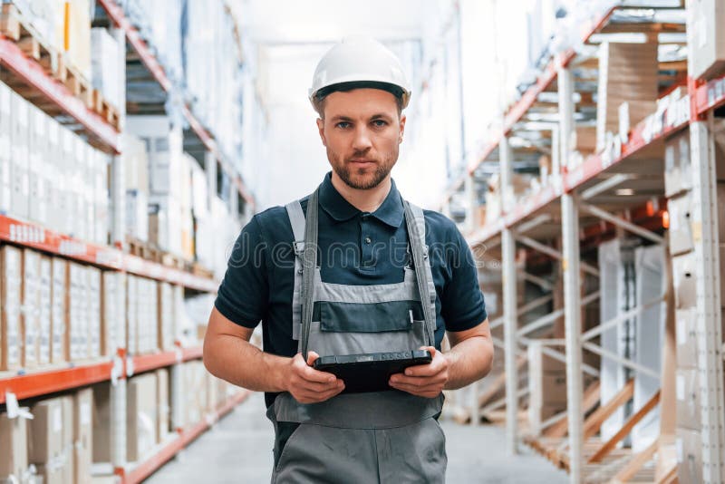 Employee in Uniform is Working in the Storage at Daytime Stock Photo ...
