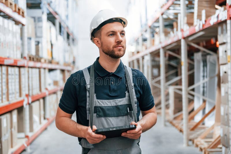 Manager is in the Store. Employee in Uniform is Working in the Storage ...