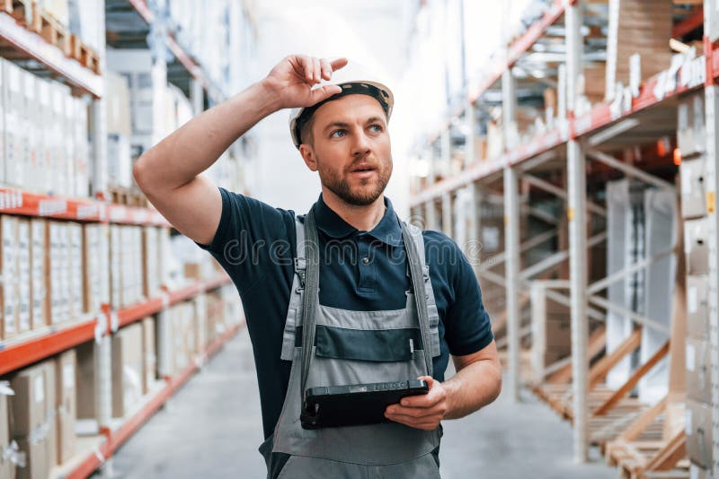 Manager is in the Store. Employee in Uniform is Working in the Storage ...