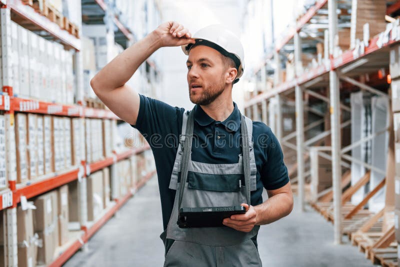 Employee in Uniform is Working in the Storage at Daytime Stock Photo ...