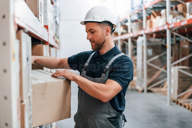Employee in Uniform is Working in the Storage at Daytime Stock Photo ...