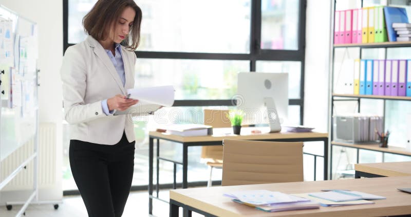 Manager Studying Documents on Paper and Walking Around Office 4k Movie ...