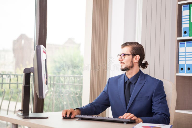 Manager in Suit Working at His Computer Next To a Glass Window Stock ...