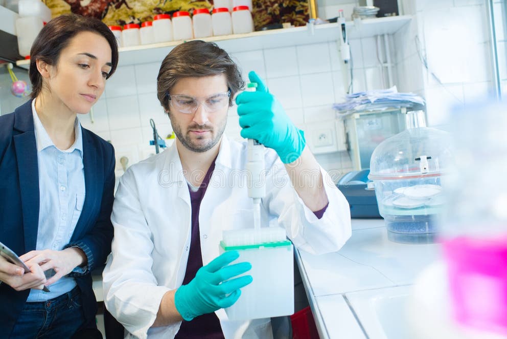 Manager Supervising Scientific Working on Research in Lab Stock Photo ...