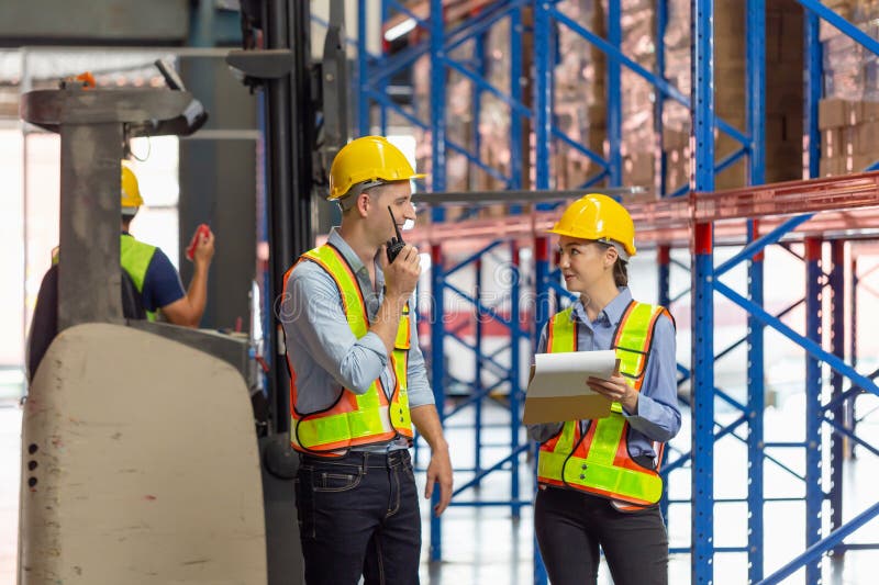 Manager and Supervisor Taking Inventory in Warehouse, Workers Working ...
