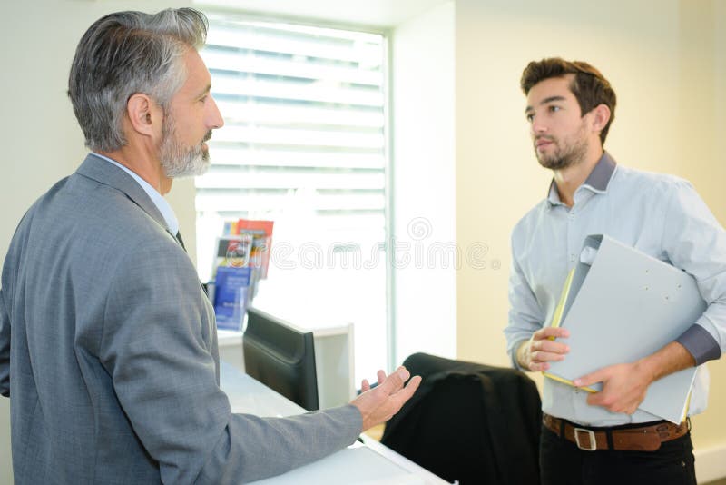 Manager Talking with Young Worker in Office Stock Image - Image of ...