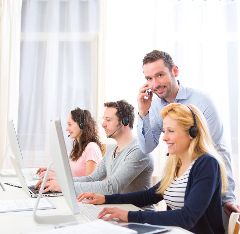 Manager Training a Young Attractive People on Computer Stock Image ...