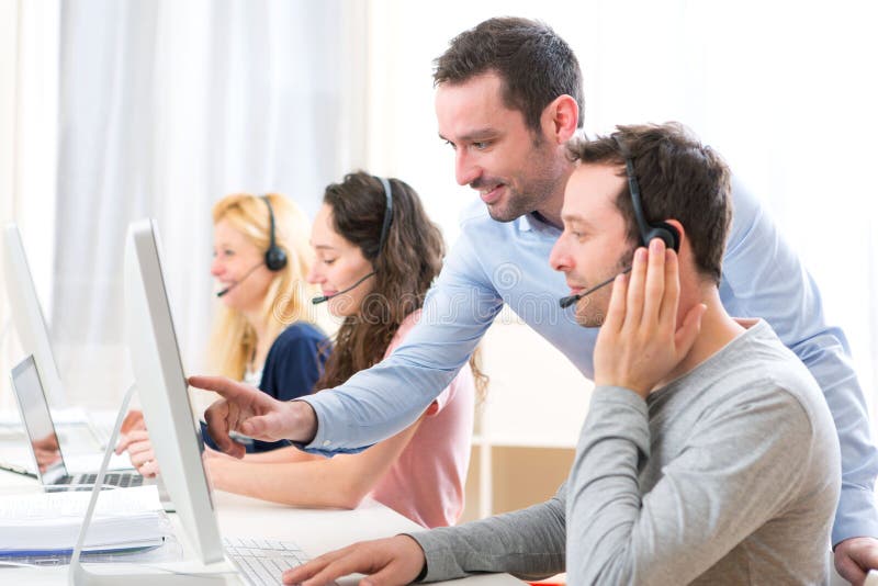 Manager Training a Young Attractive People on Computer Stock Photo ...