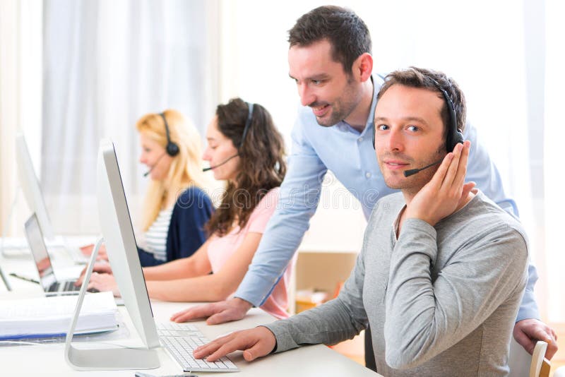 Manager Training a Young Attractive People on Computer Stock Photo ...