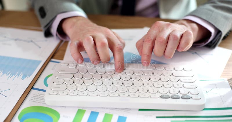 Manager Types on Computer Keyboard and Documents with Graphics ...