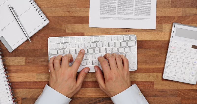 Manager is Typing on Computer Keyboard at Wooden Table with Documents ...