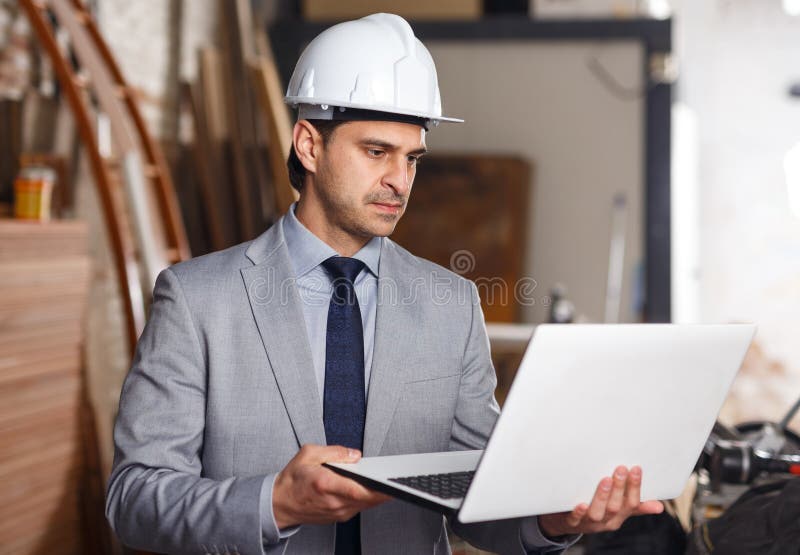 Manager Using Laptop with Blueprints Stock Photo - Image of builder ...