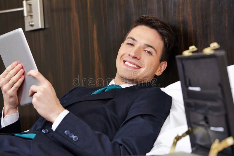 Manager Using Tablet Computer in Hotel Bed Stock Photo - Image of ...