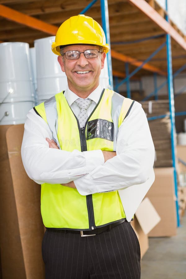 Manager Wearing Hard Hat in Warehouse Stock Photo - Image of mature ...