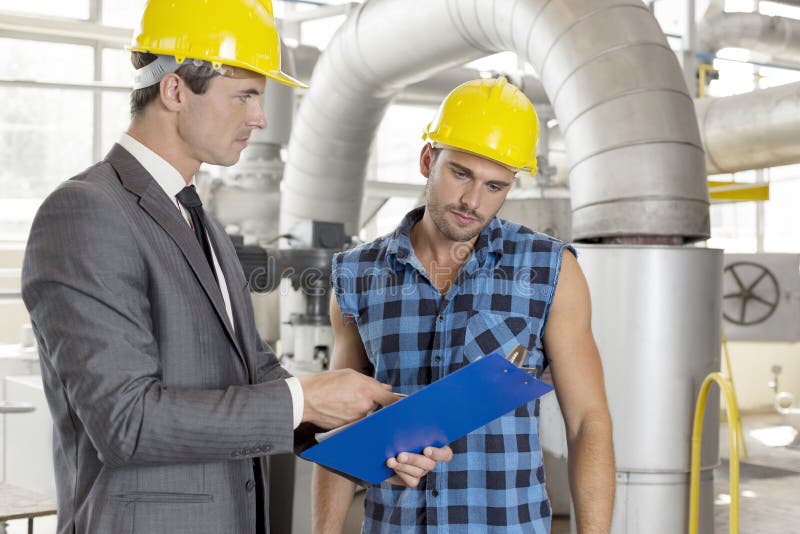Two Workers Discussing Project Outdoors Stock Image - Image of ...