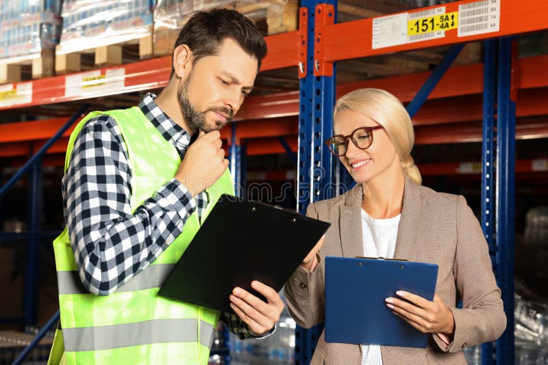 Manager and Worker in Warehouse with Lots of Products Stock Image ...