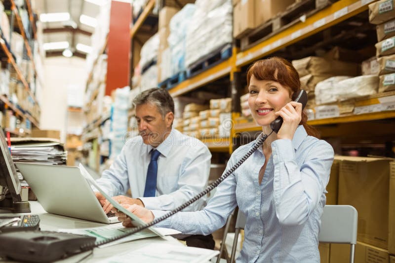 Manager Working on Laptop and Talking on Phone at Desk Stock Photo ...