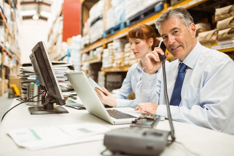 Manager Working on Laptop and Talking on Phone at Desk Stock Image ...