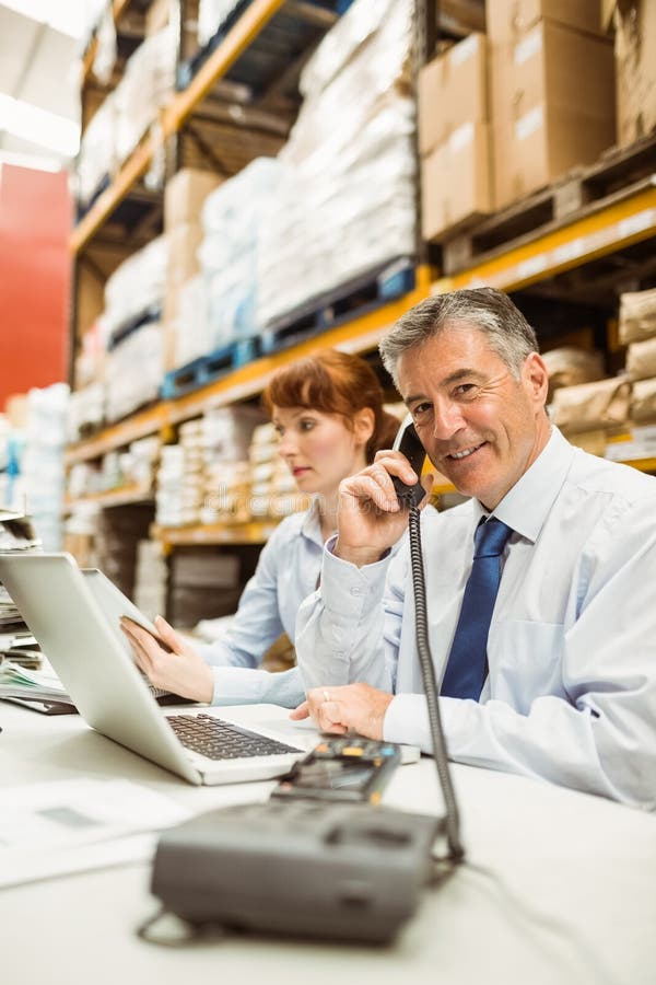 Man Talking on Phone at Desk in Office Stock Photo - Image of cellphone ...