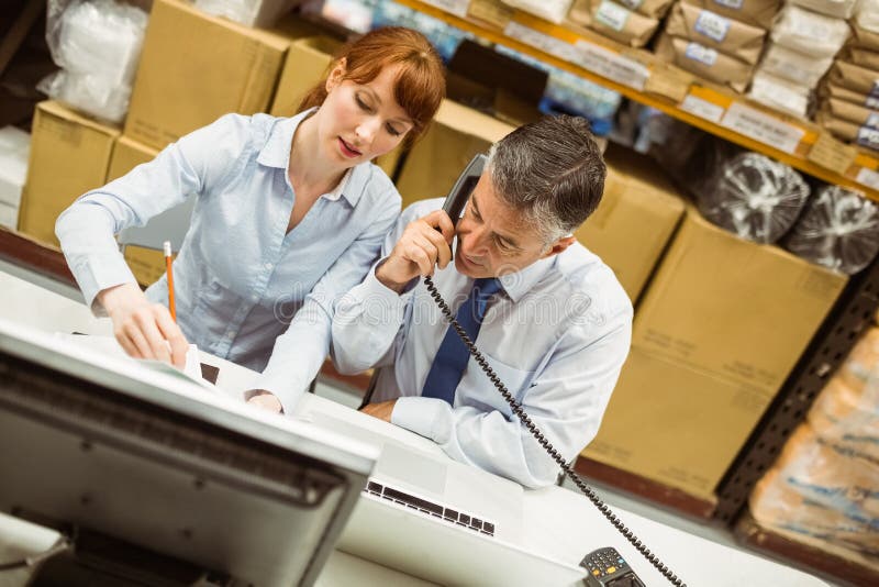 Manager Working on Laptop and Talking on Phone at Desk Stock Image ...