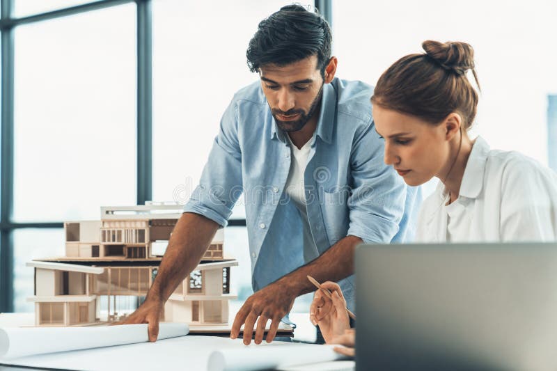 Manager Working by Using Laptop while Engineer Inspect House Model ...