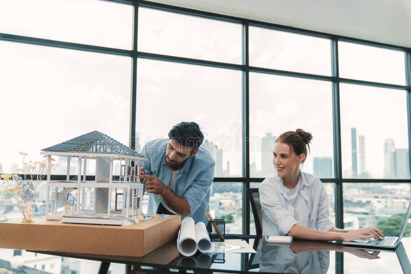 Manager Working by Using Laptop while Engineer Inspect House Model ...