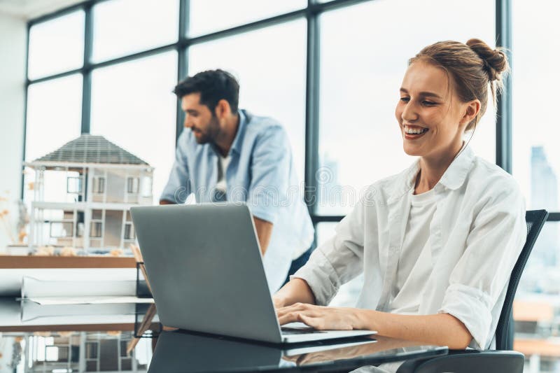 Manager Working by Using Laptop while Engineer Inspect House Model ...