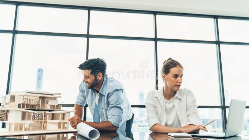 Manager Working by Using Laptop while Engineer Inspect House Model ...