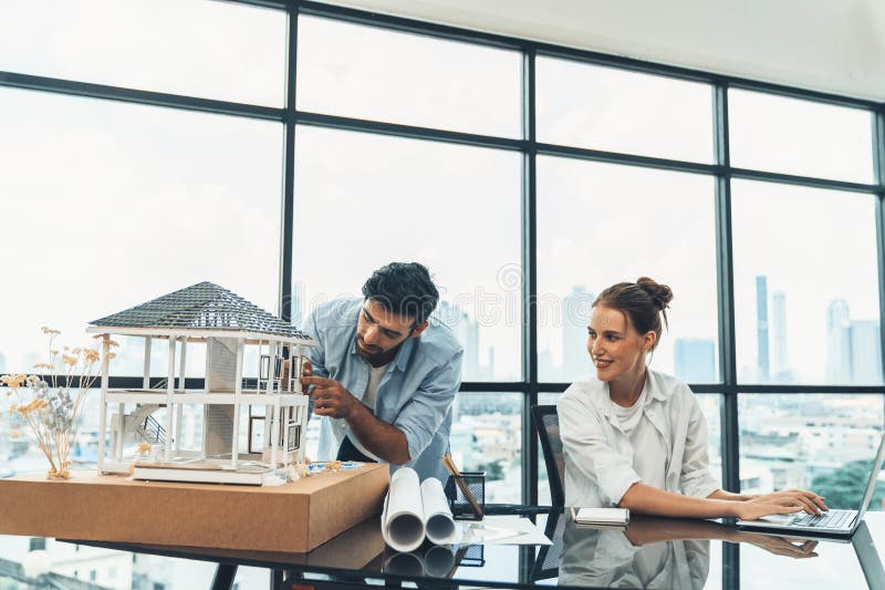 Manager Working by Using Laptop while Engineer Inspect House Model ...