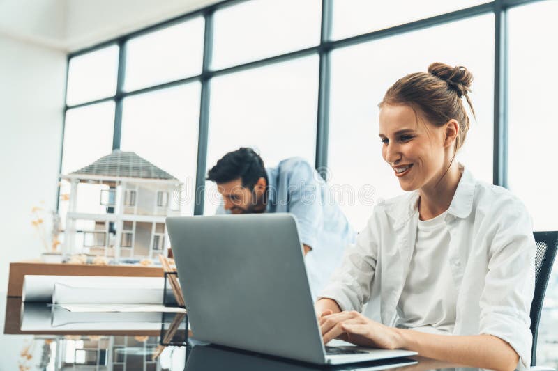 Manager Working by Using Laptop while Engineer Inspect House Model ...